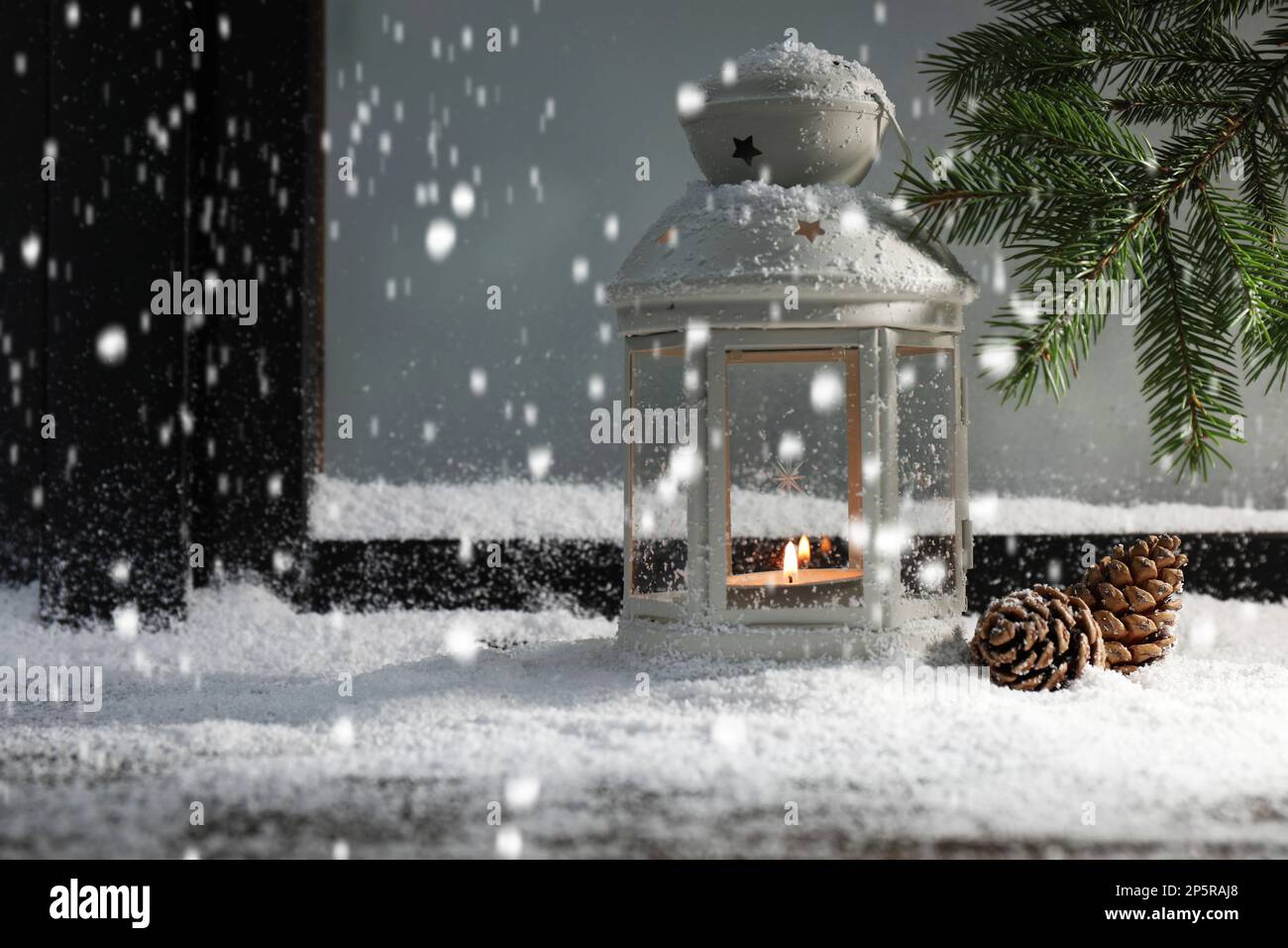 Snow falling onto window sill with Christmas lantern, outdoors. Space ...