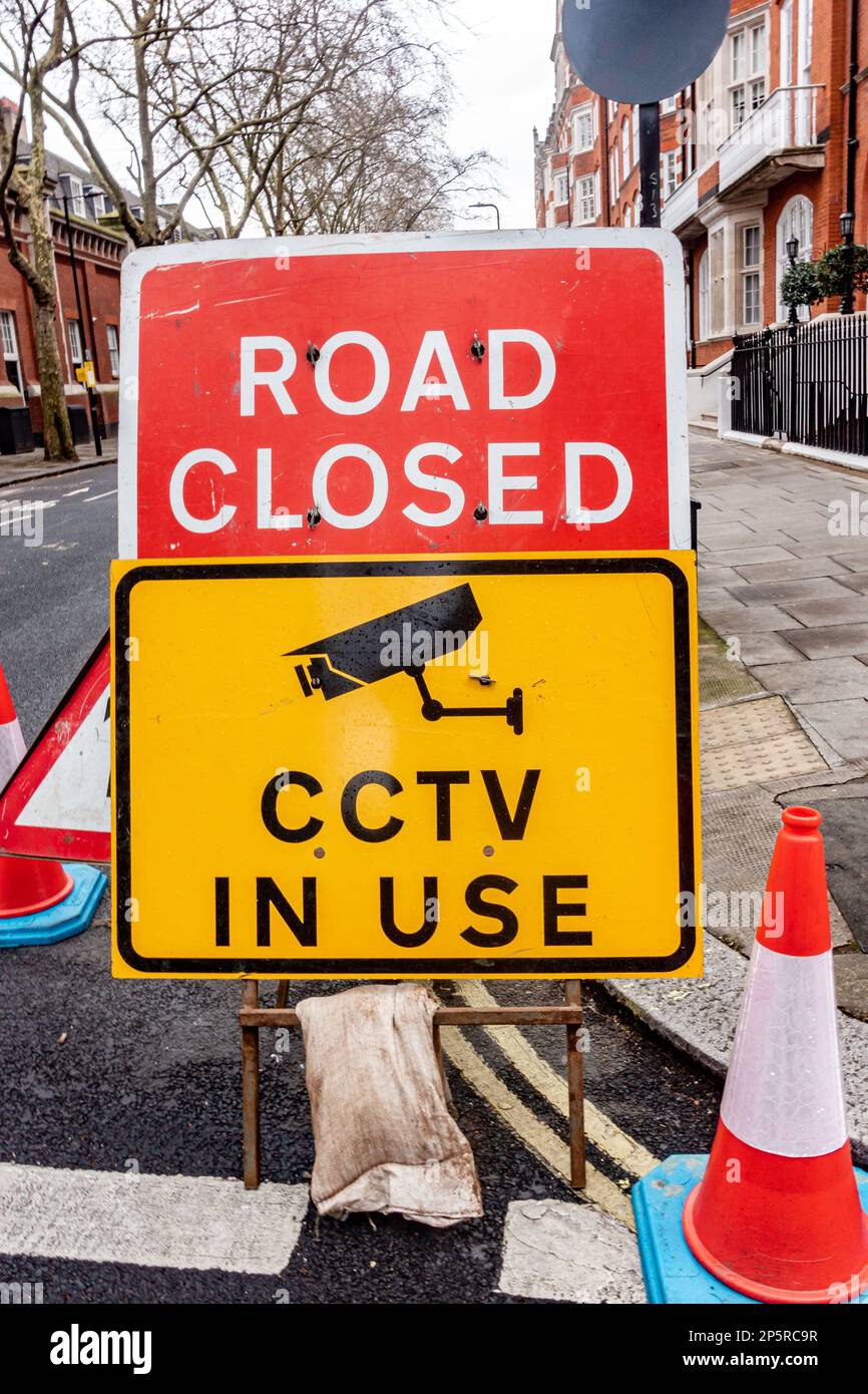 Road signs informing drivers that a road is closed and warning that it ...