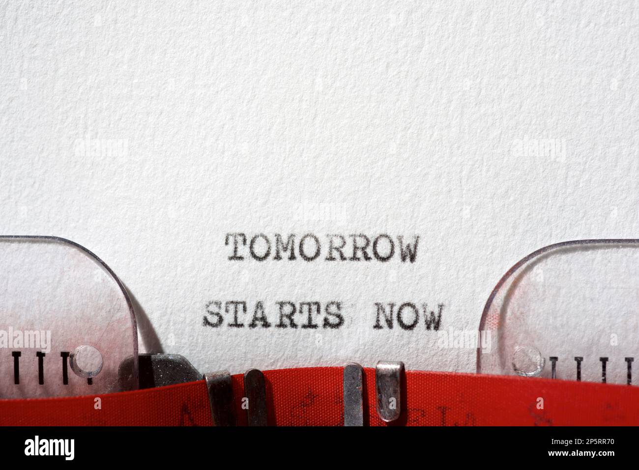 Tomorrow starts now text written with a typewriter Stock Photo - Alamy