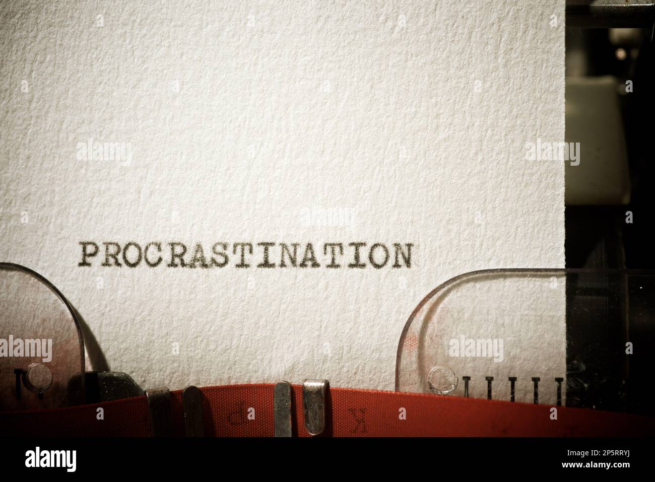 Procrastination word written with a typewriter Stock Photo - Alamy