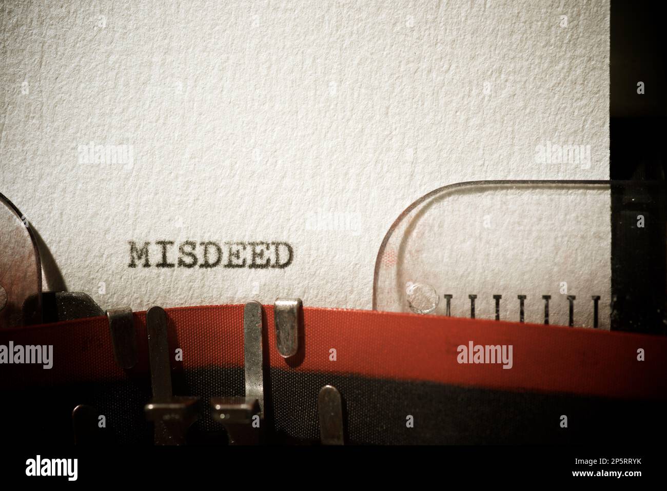 Misdeed word written with a typewriter Stock Photo - Alamy