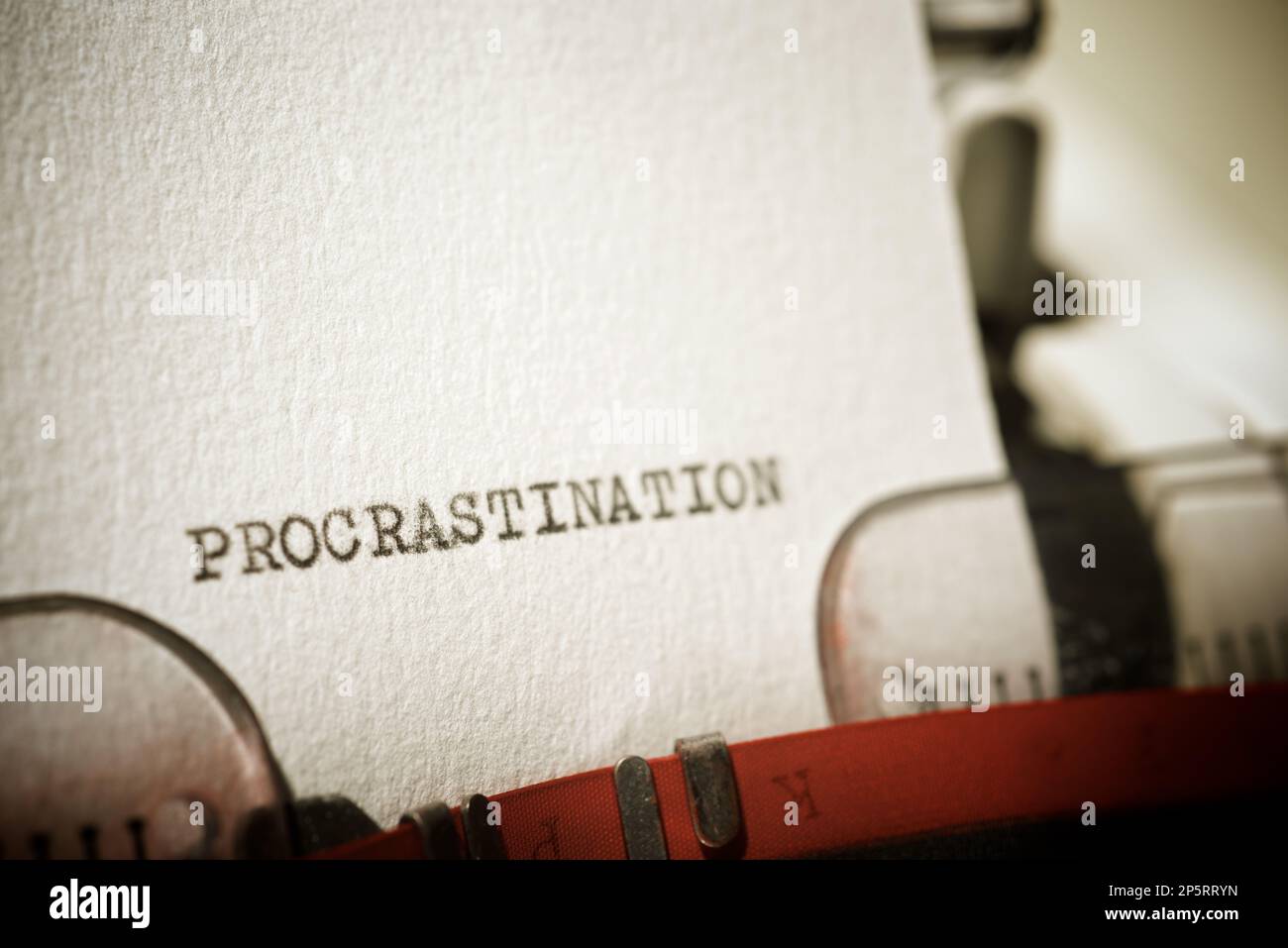 Procrastination word written with a typewriter Stock Photo - Alamy