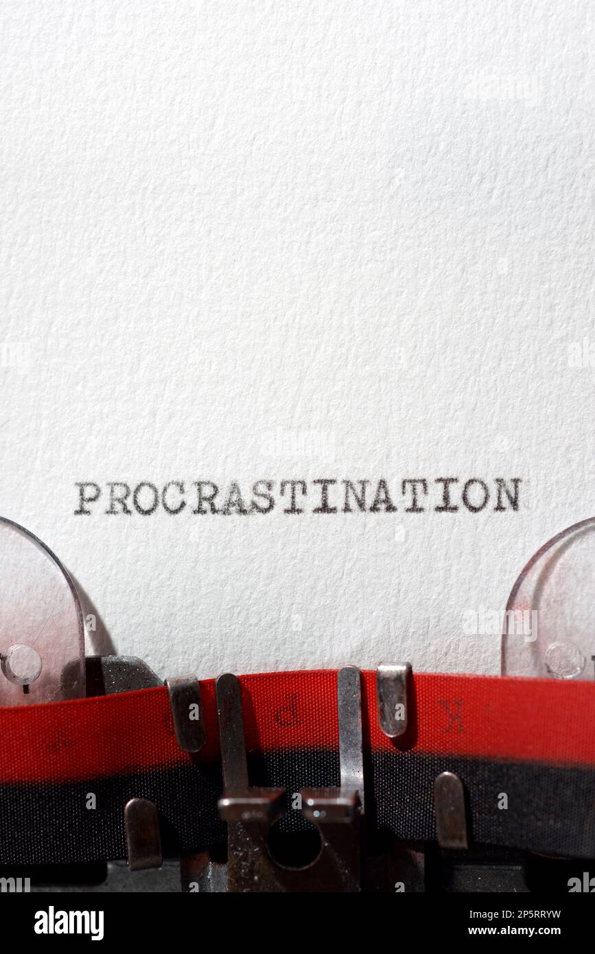 Procrastination word written with a typewriter Stock Photo - Alamy
