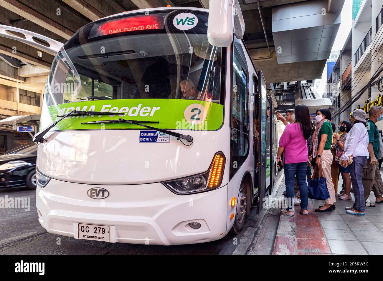 Passengers boarding electric shuttle bus at terminus, Bangkok, Thailand ...