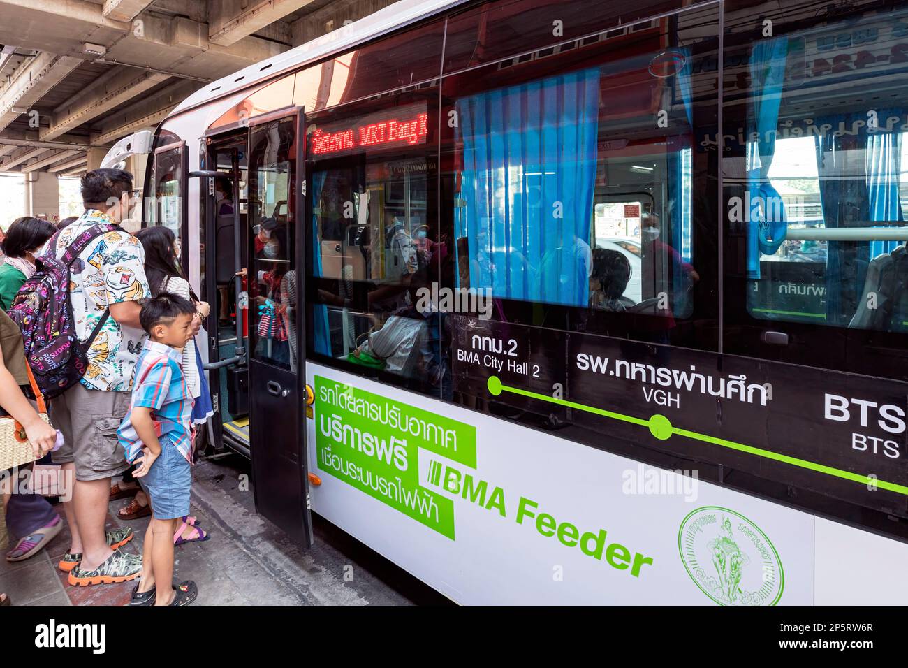 Passengers boarding electric shuttle bus at terminus, Bangkok, Thailand ...