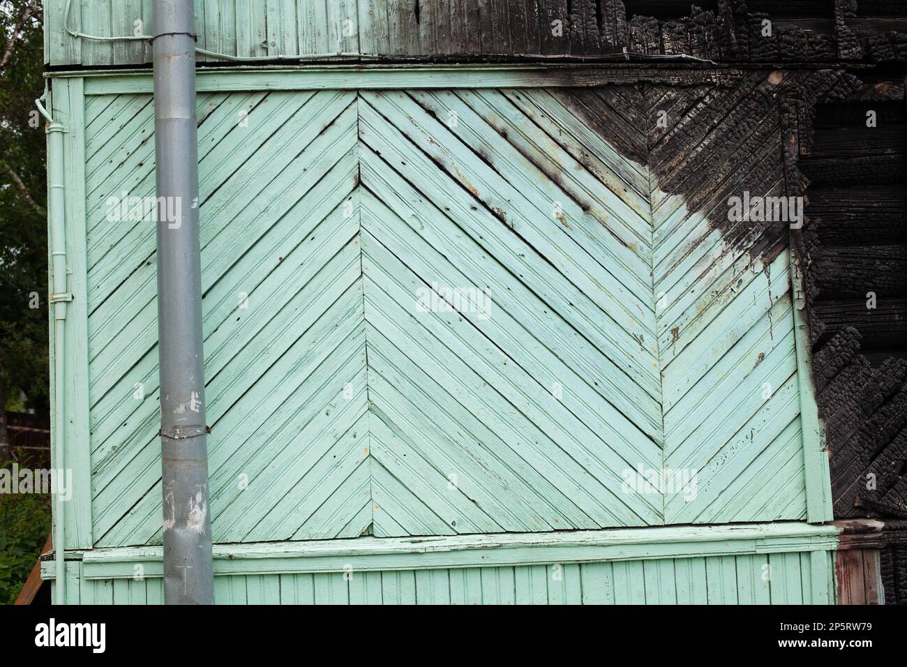 Half burned blue house wall Stock Photo - Alamy