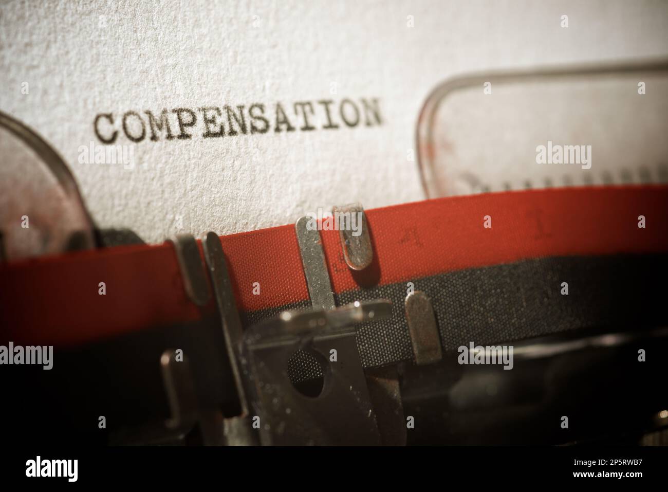 Compensation word written with a typewriter Stock Photo - Alamy