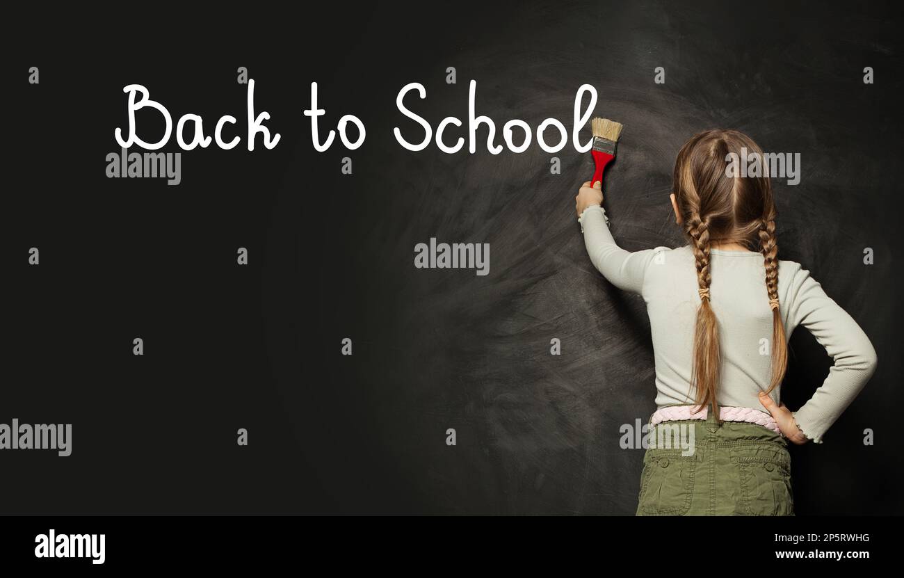 Child girl writing on the blackboard with brush. Back to school, study ...