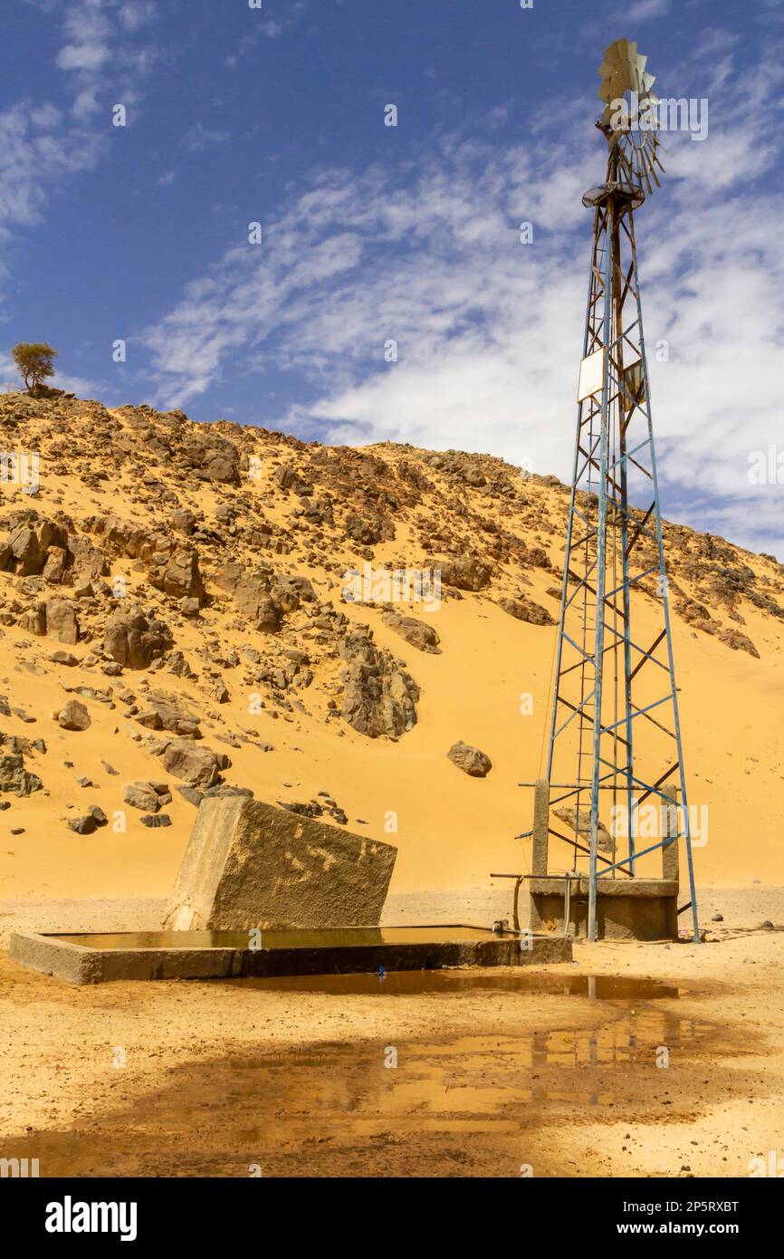 A well with a windmill pumping water. South of Algeria region of Illizi ...