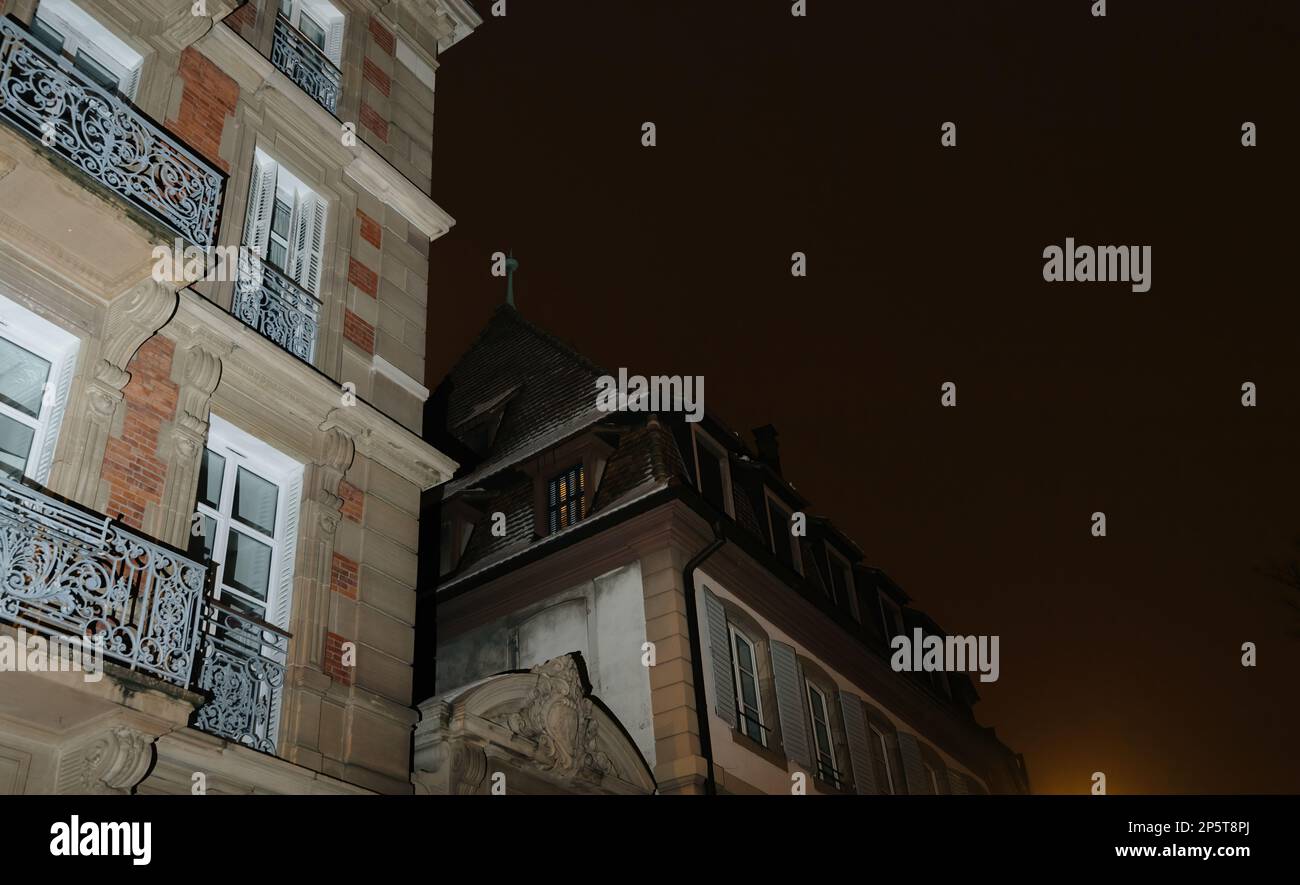Low-angle view of house apartment building at night with balconies ...