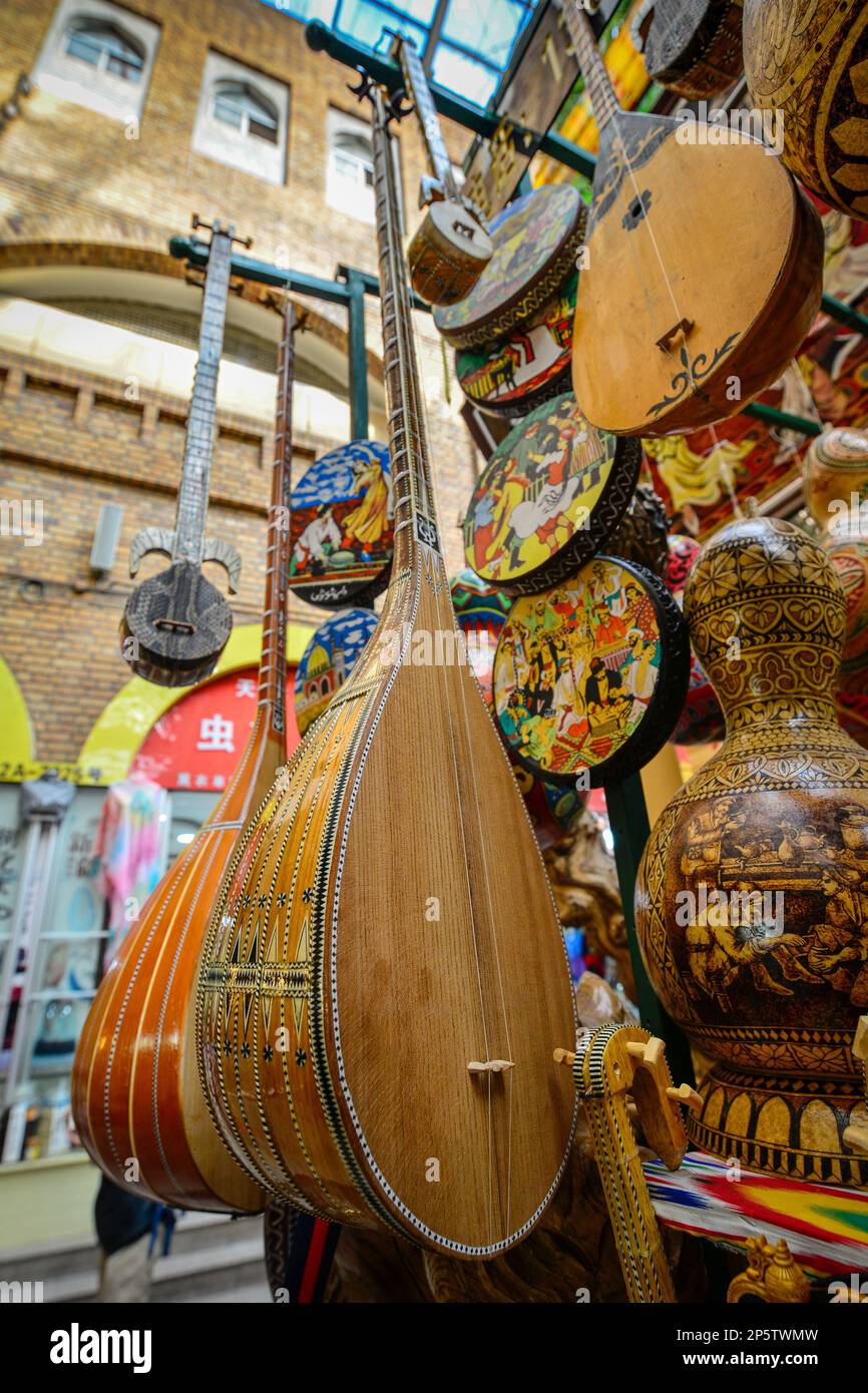 Vendors selling dutar in Grand Bazaar, Xinjiang, China Stock Photo - Alamy