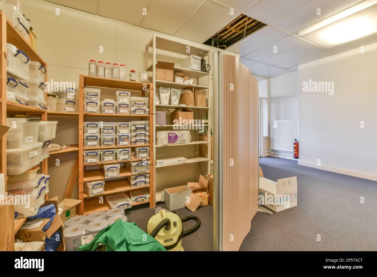 the inside of a room with many items on shelves and boxes all over the ...