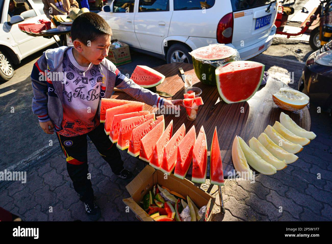 Watermelon vendors at a market in Urumqi, Xinjiang, China Stock Photo ...