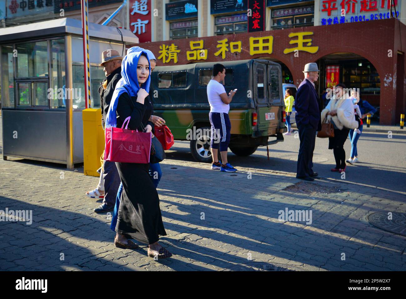 Residents wearing Uyghur traditional turbans and square caps on the ...
