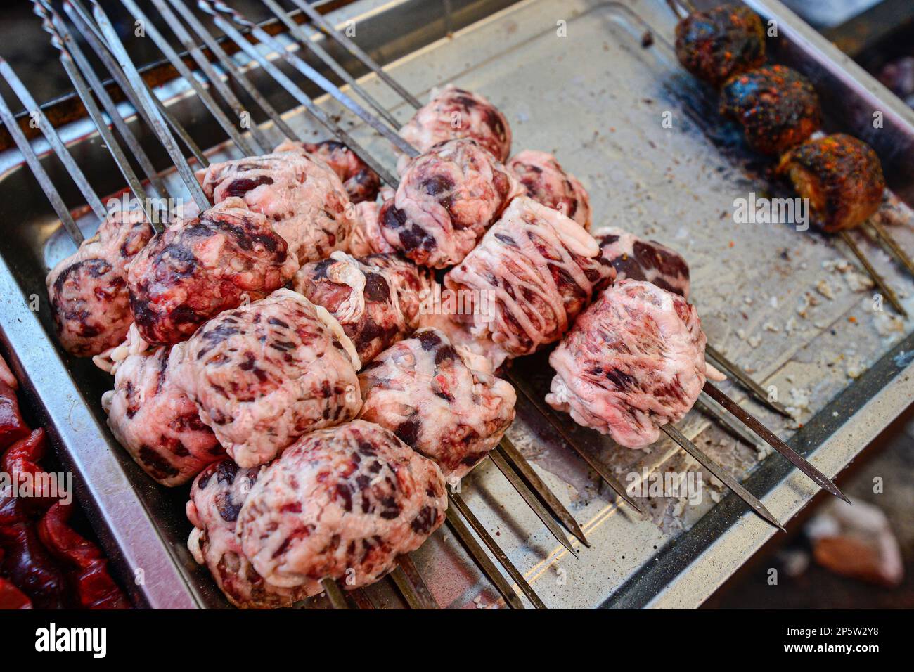Vendors selling barbecued meat and local Uighur food in a traditional ...