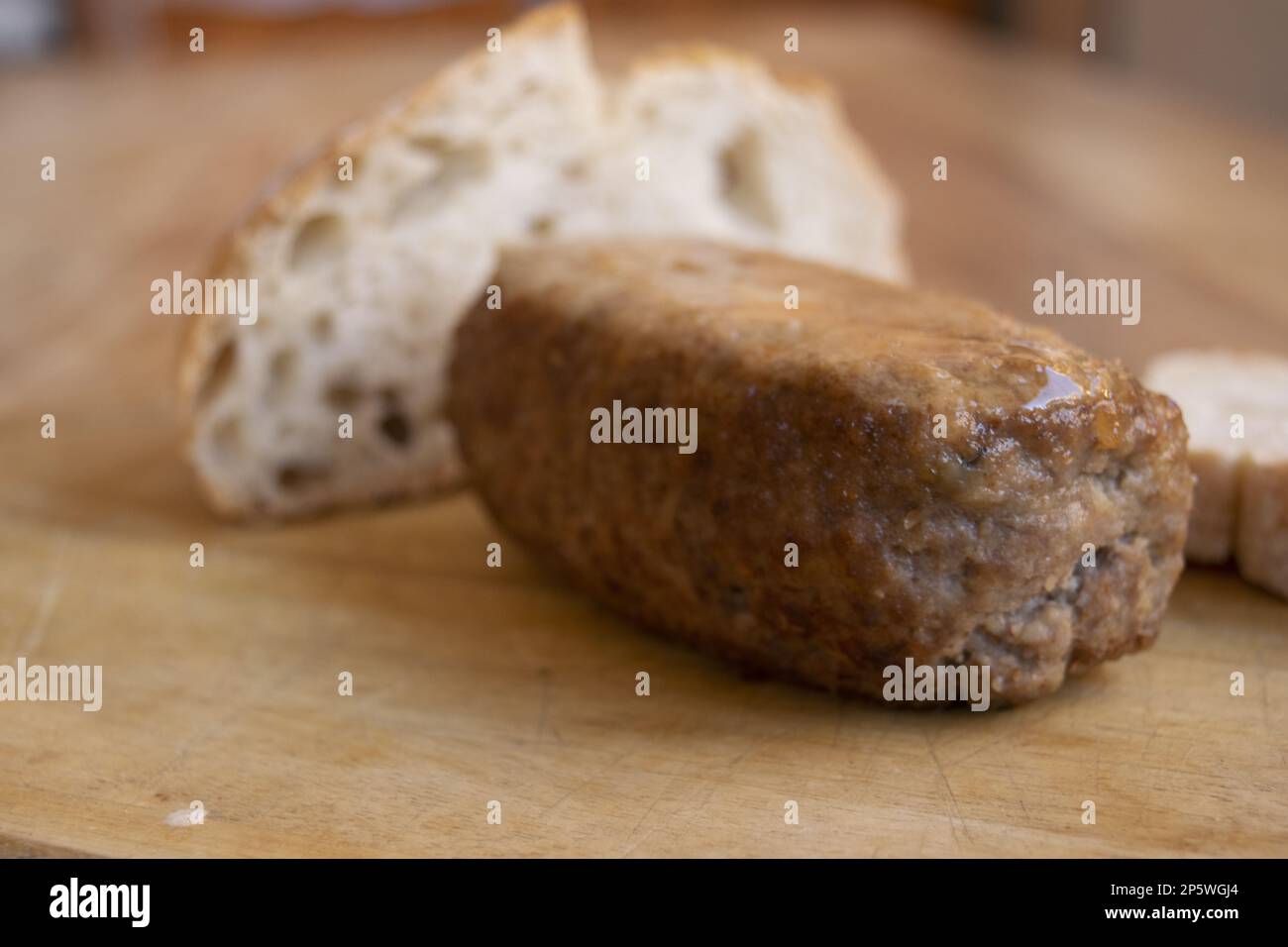 beef meatloaf with a loaf of bread behind it Stock Photo - Alamy