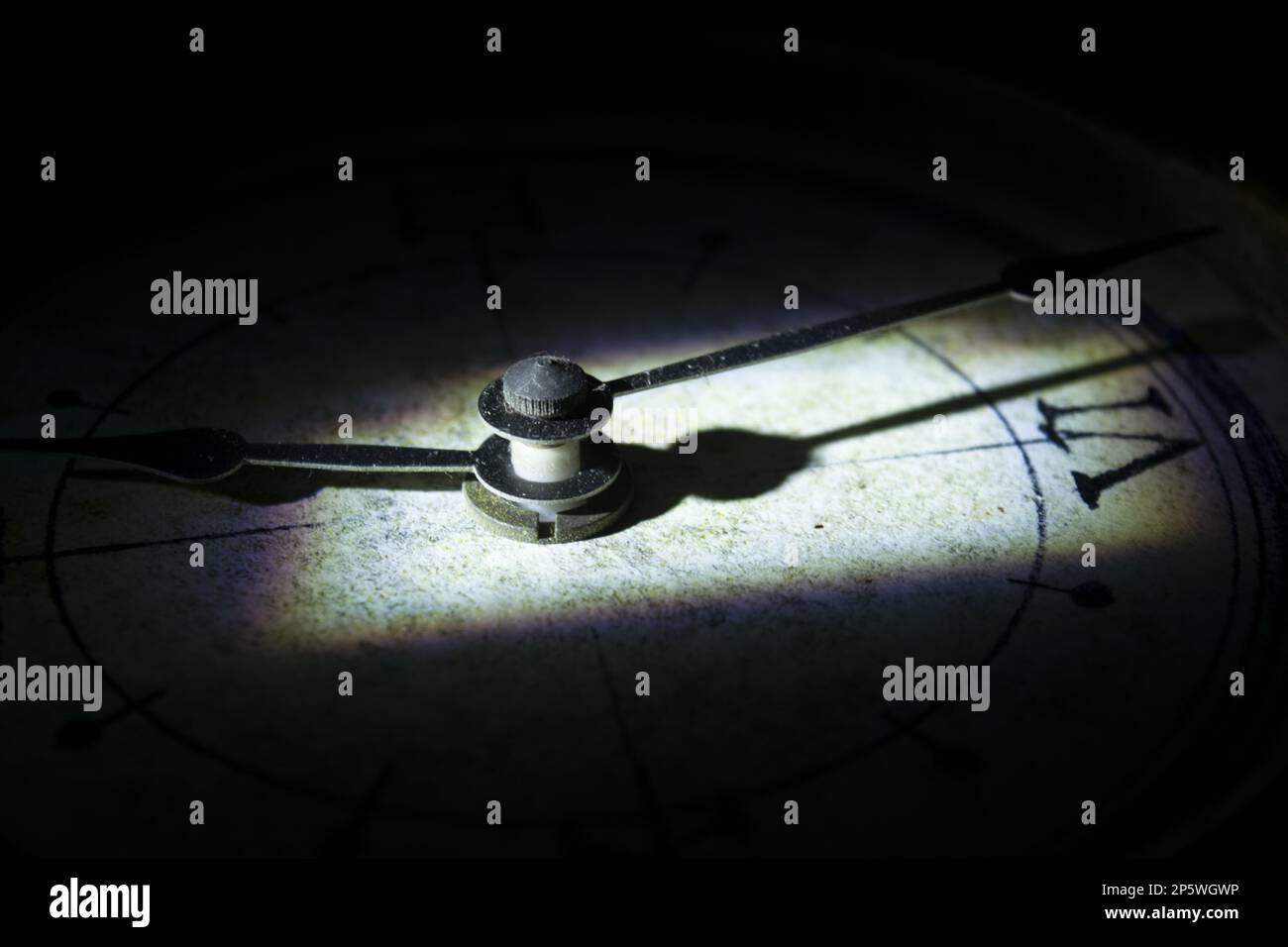concept of time with the face of an old wall clock in directional light ...