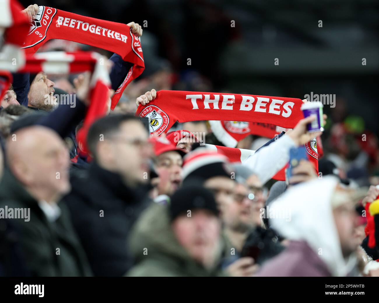 London, England, 6th March 2023. Brentford fans hold up scarves during ...