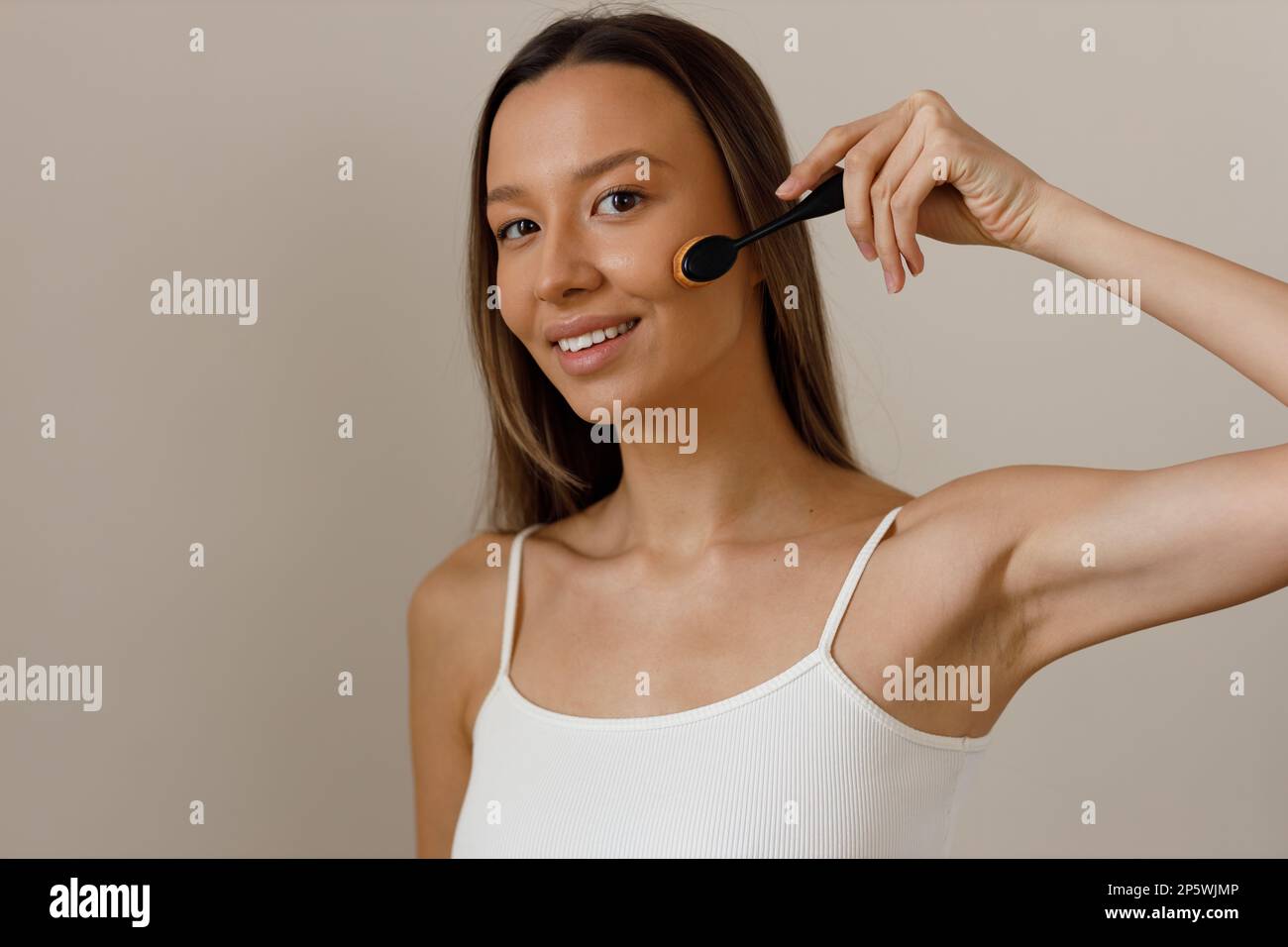 Beautiful young smiling blonde woman with long hair, dressed in short ...