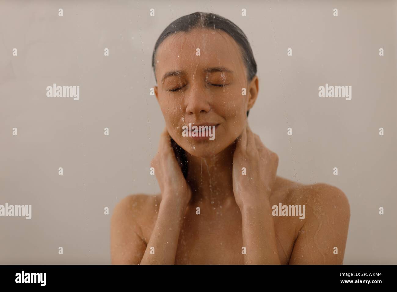 Young woman under trickles water in pleasure shower. Beautiful girl ... Young woman under trickles water in pleasure shower. Beautiful girl ...