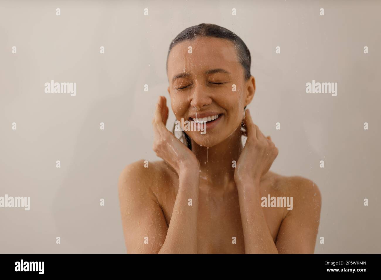 Young woman under the trickles of water in pleasure shower. Beautiful ... Young woman under the trickles of water in pleasure shower. Beautiful ...