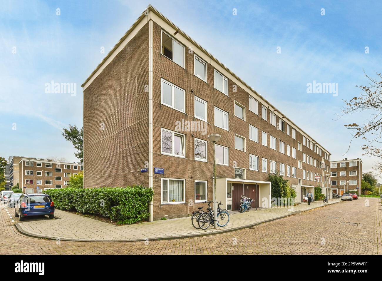 a brick building with bicycles parked on the street next to it and ...