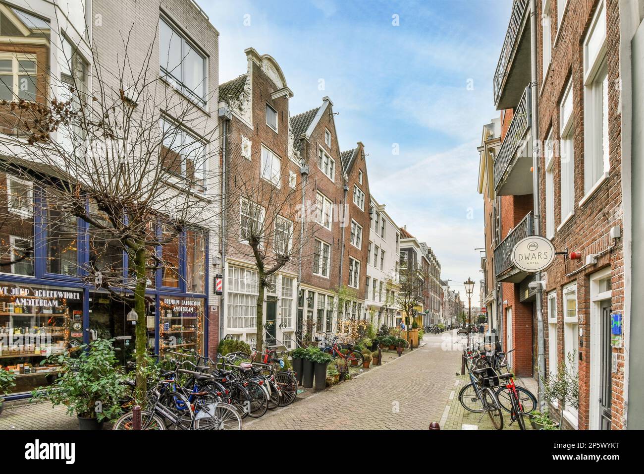 some bikes parked on the side of a street in an old european town, with ...