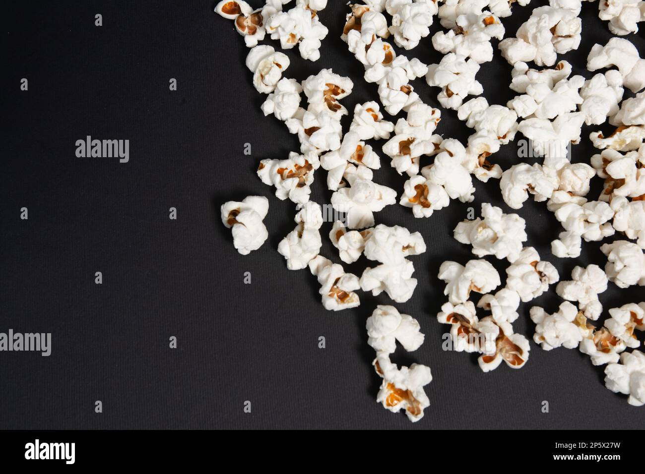 fried popcorn on black background close-up, ready-to-eat food, corn ...