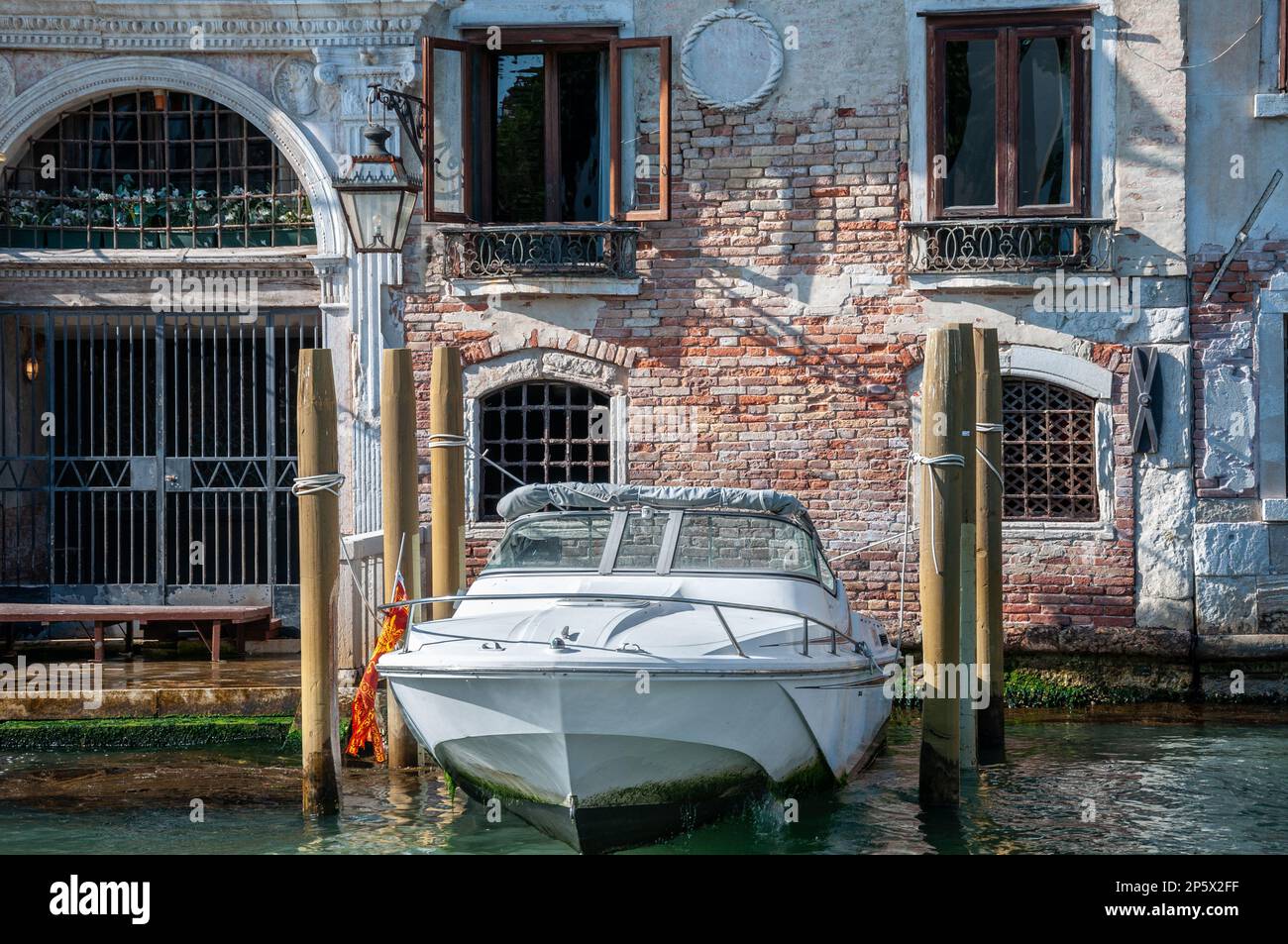 Gondolas and boats float on the magnificent Grand Canal in sunny Venice ...