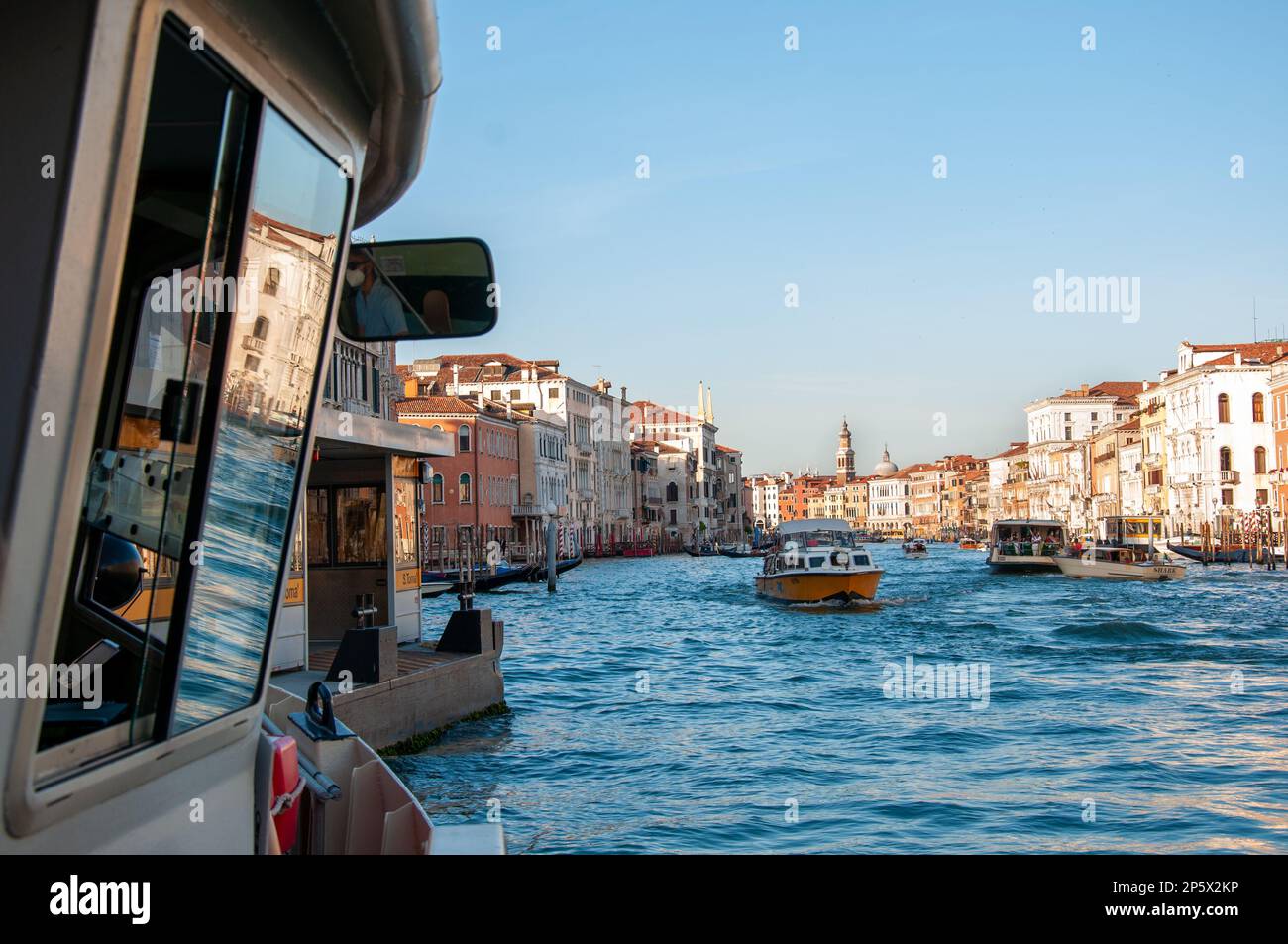 Gondolas and boats float on the magnificent Grand Canal in sunny Venice ...