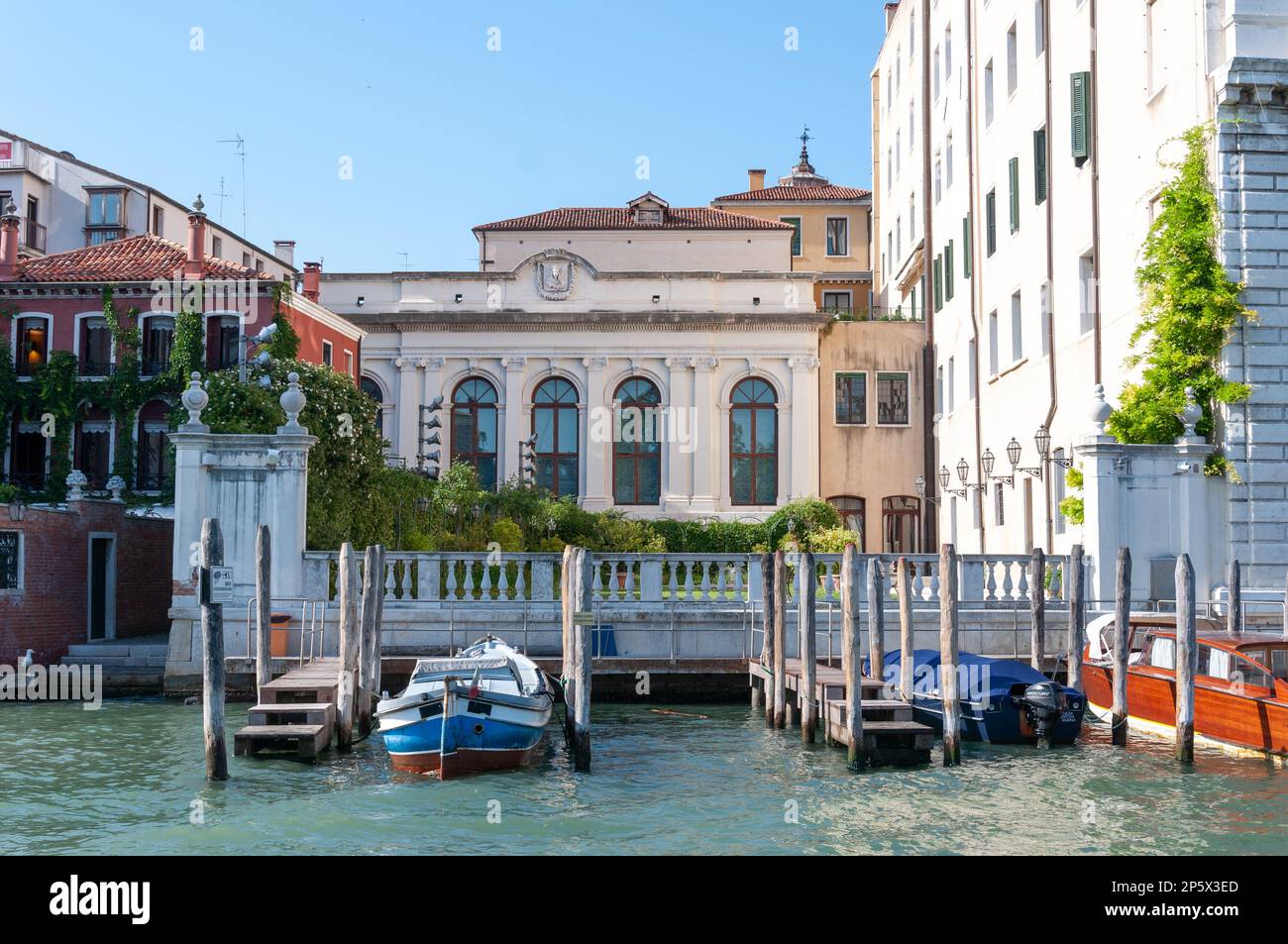 Gondolas and boats float on the magnificent Grand Canal in sunny Venice ...