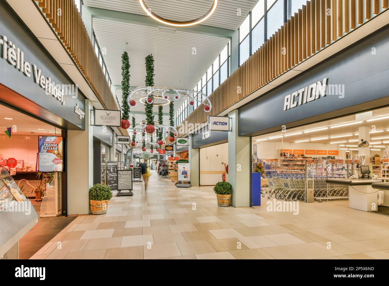 the inside of a shopping mall with people walking by and looking at ...