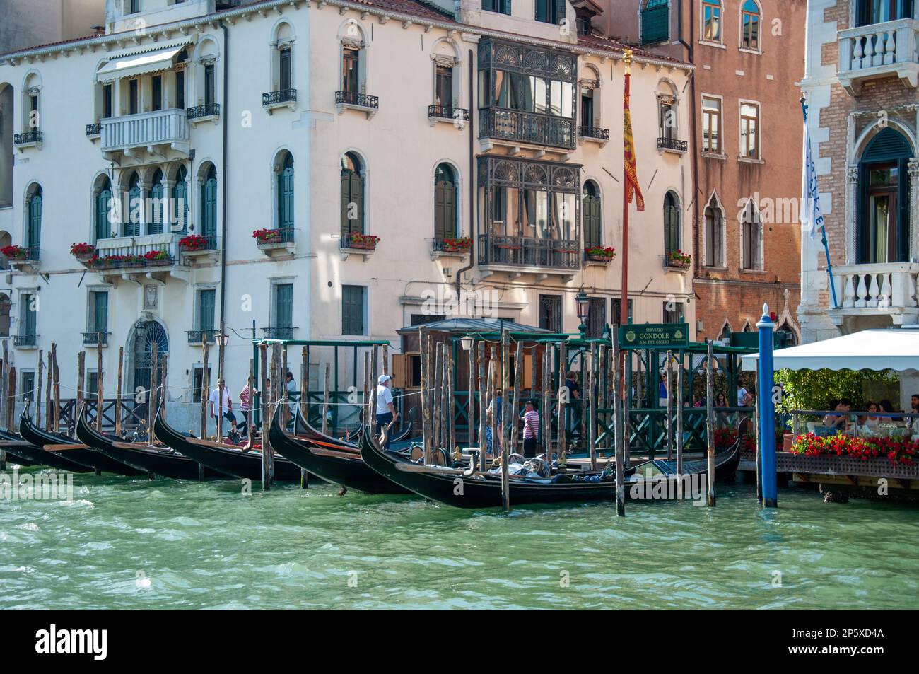 Gondolas and boats float on the magnificent Grand Canal in sunny Venice ...
