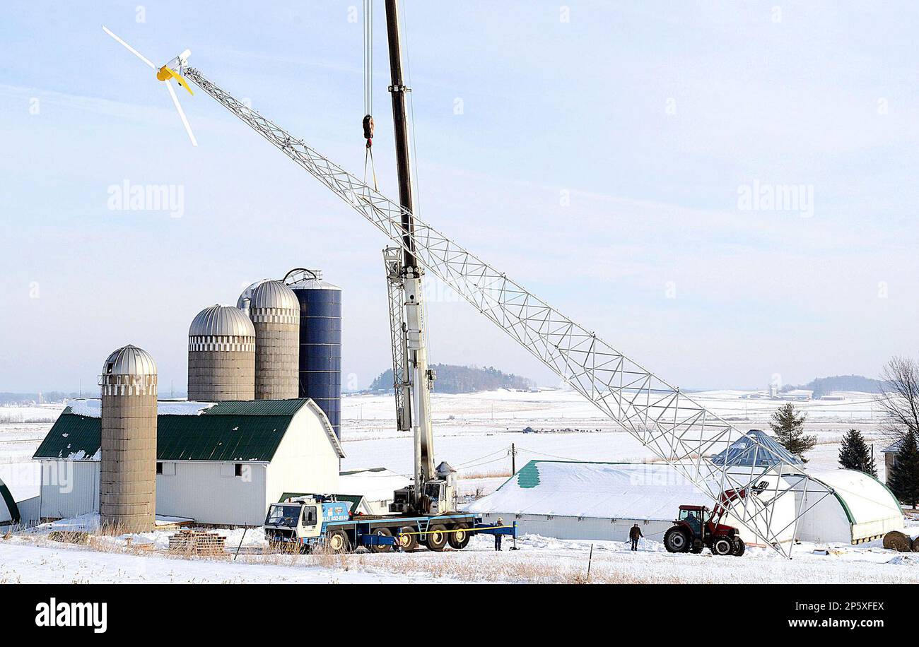 Workers use a large crane to erect a wind turbine Friday, Dec. 14, 2012 ...