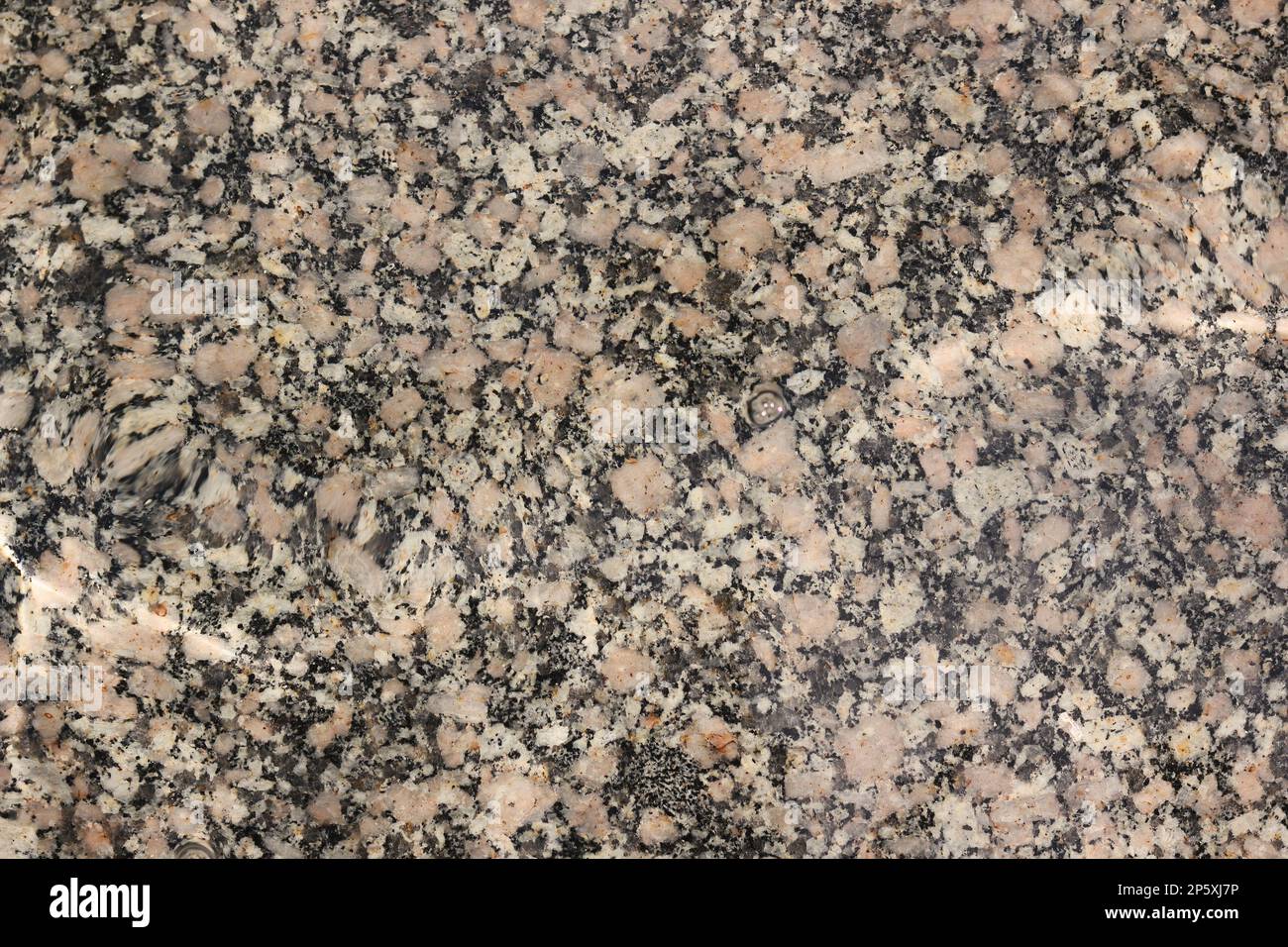 A slab of natural granite as seen under the surface of the water Stock ...