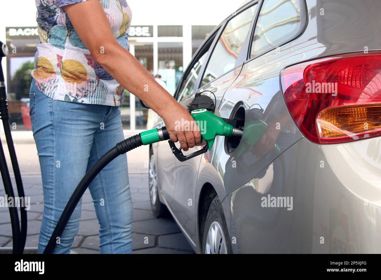 woman refueling car Stock Photo - Alamy