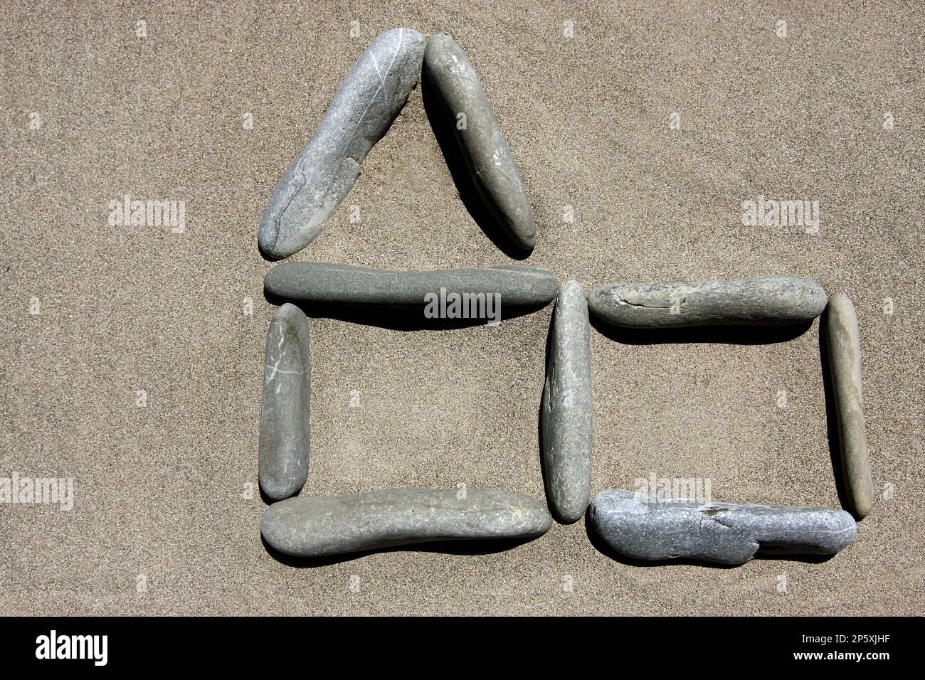 outline of a house of stones in the sand Stock Photo - Alamy