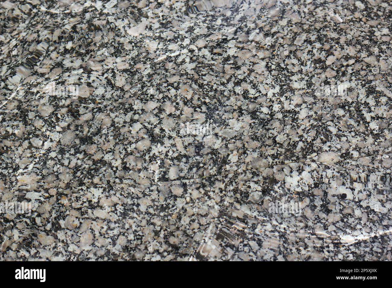 A slab of natural granite as seen under the surface of the water Stock ...