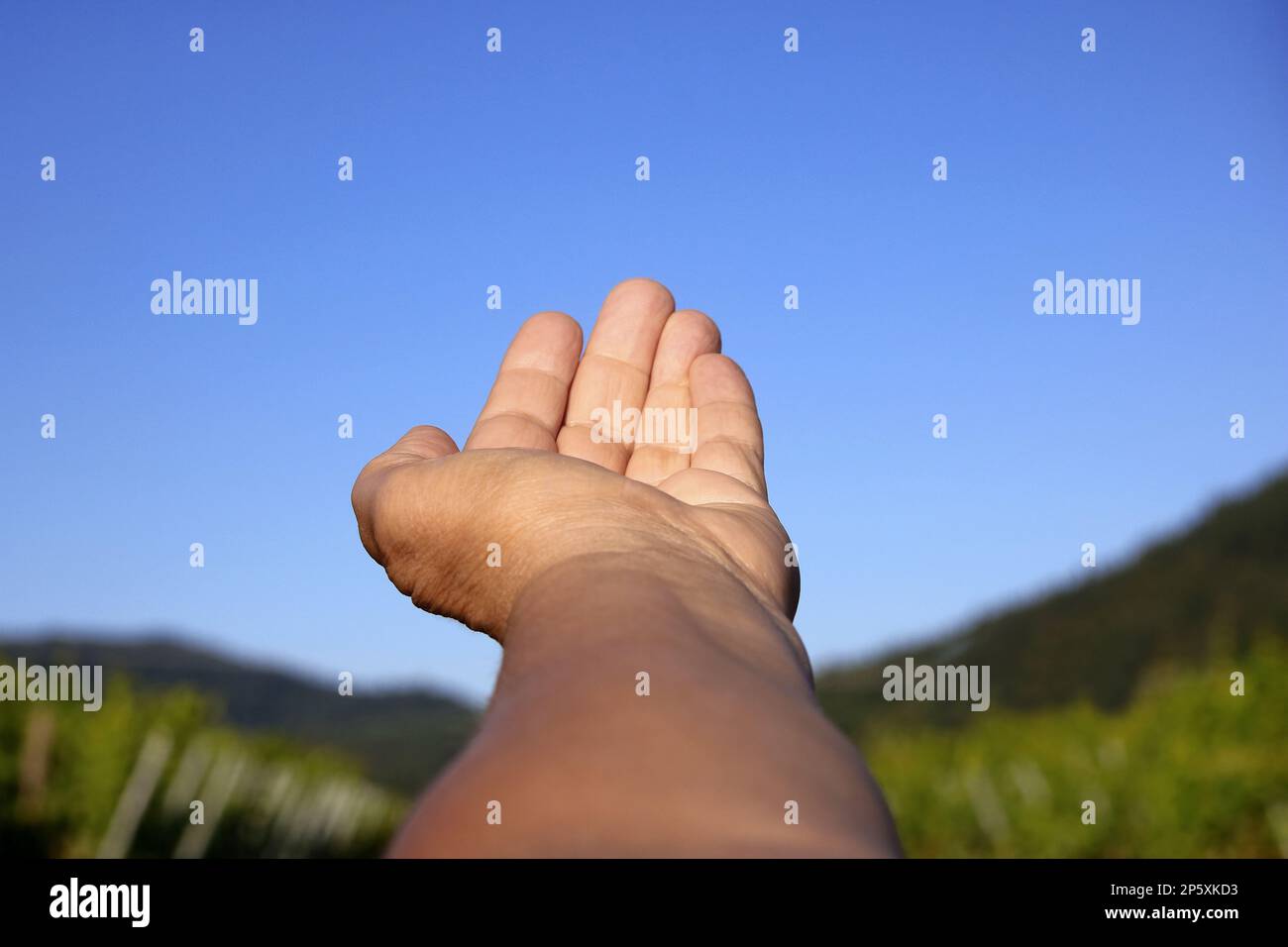 open hand in front of blue sky, it is more blessed to give than to ...