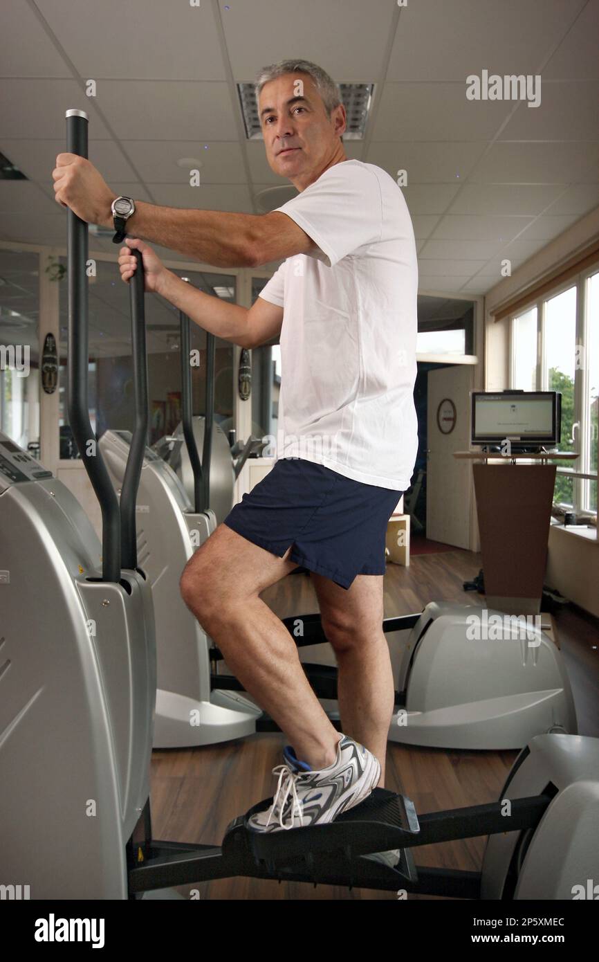 elderly man on a step machine in the gym Stock Photo - Alamy