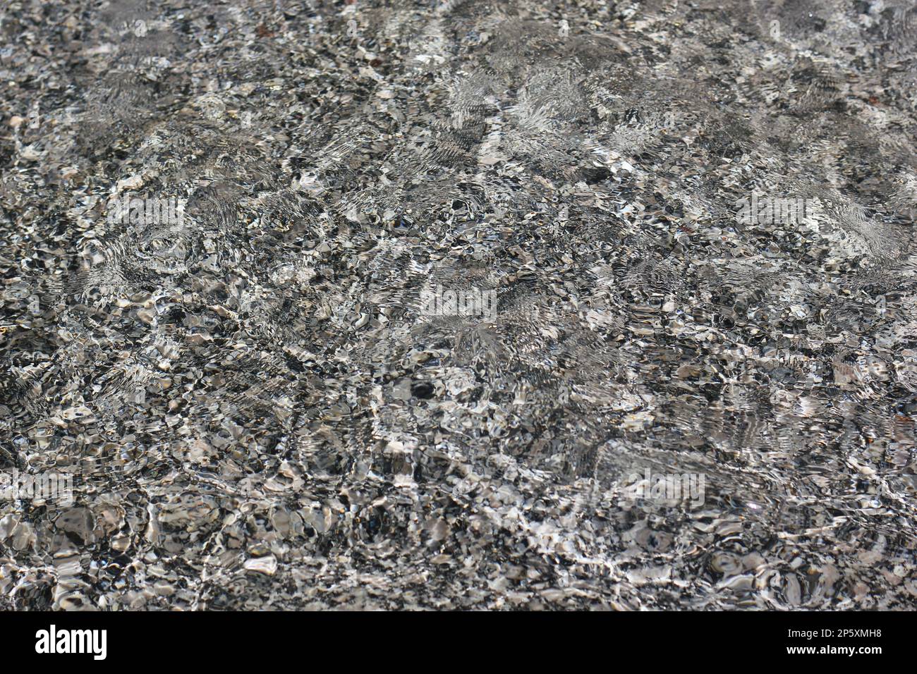 A slab of natural granite as seen under the surface of the water Stock ...