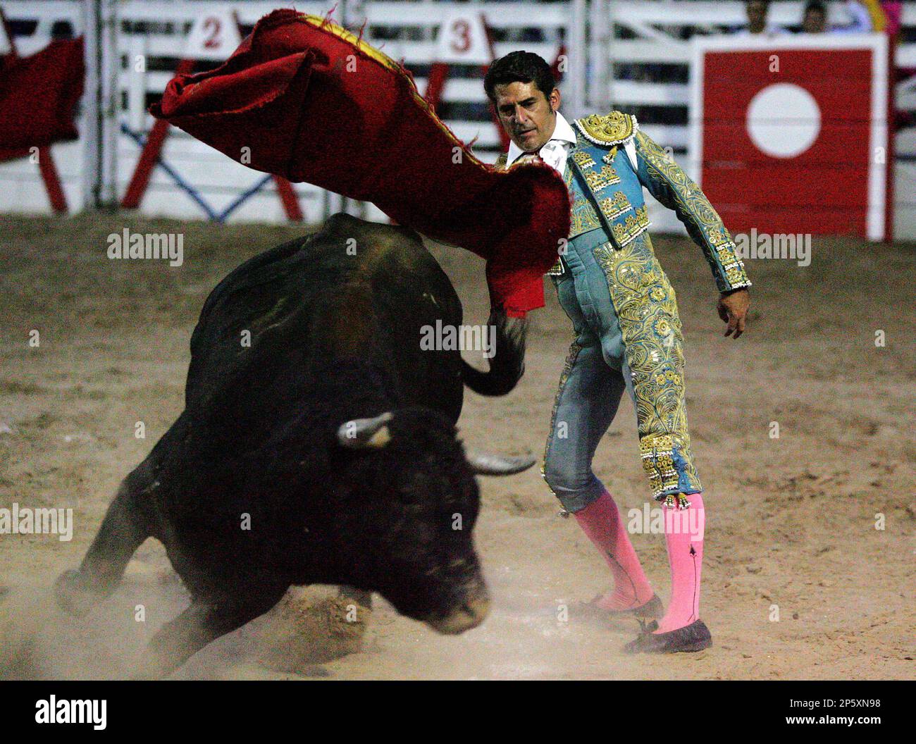 Professional bullfighter Manolo Martinez Jr. tames a bull in front of a ...