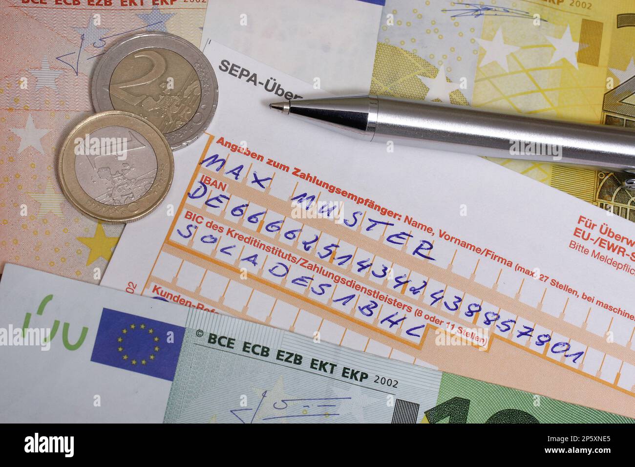 analog SEPA credit transfer and Euro bills and coins and ballpen Stock ...