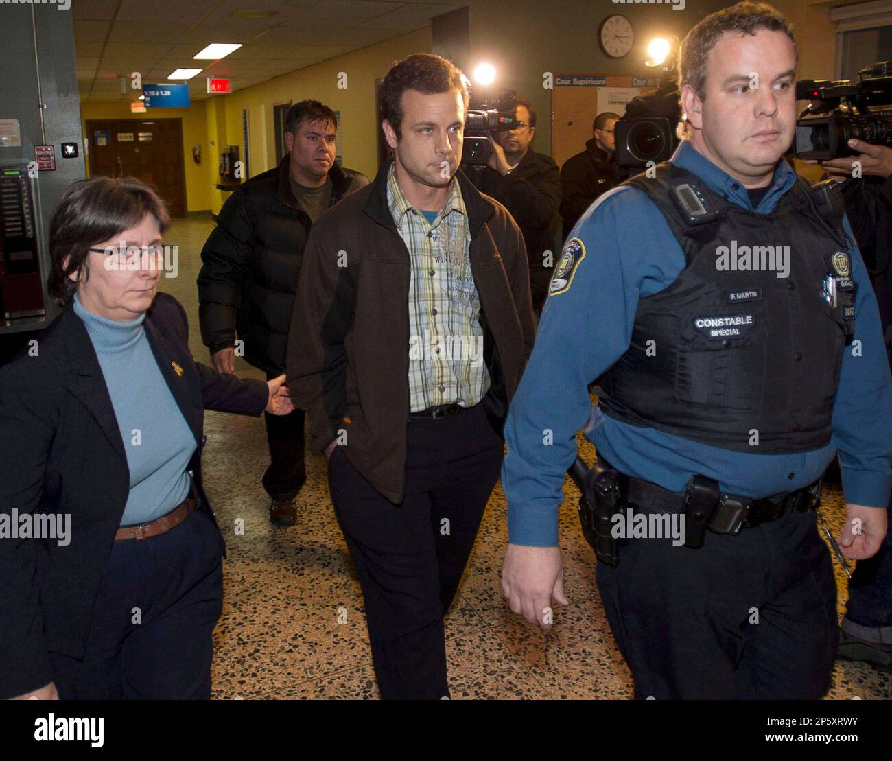 In this Dec. 5, 2012 photo, Patrick Desautels, center, arrives for the ...