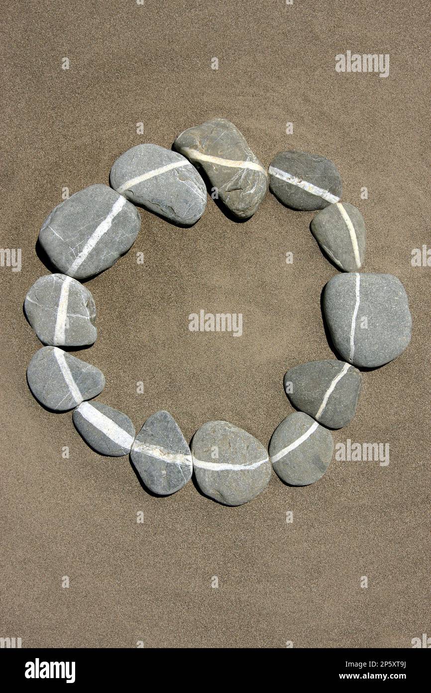 stone circle on sand made of stones with white stripe Stock Photo - Alamy