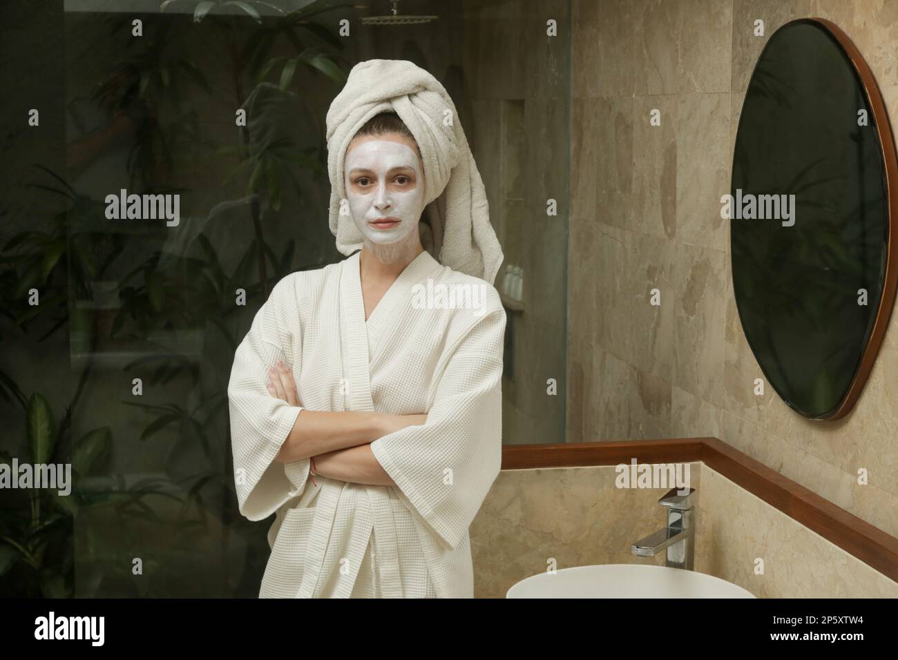 Portrait of a woman with beauty face mask in the bathroom, skin care ...