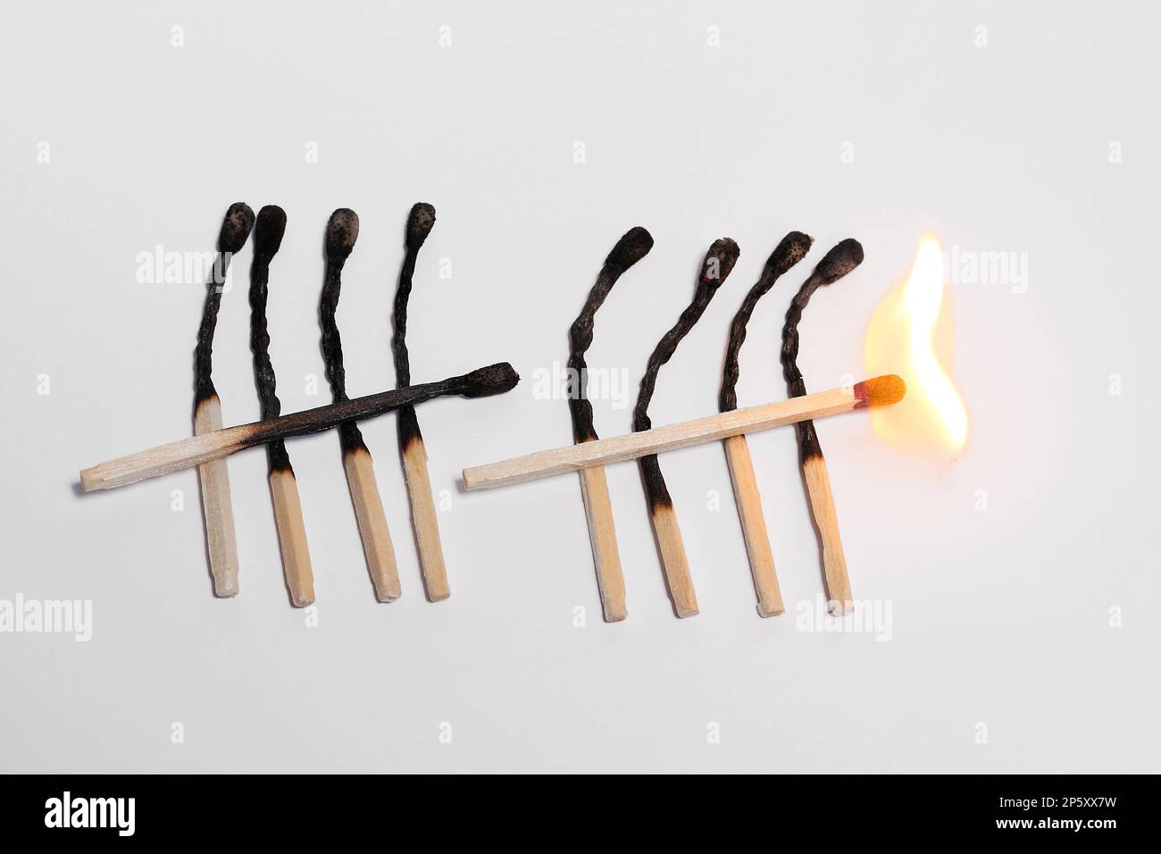 group of burnt off matches, single one still burning Stock Photo - Alamy