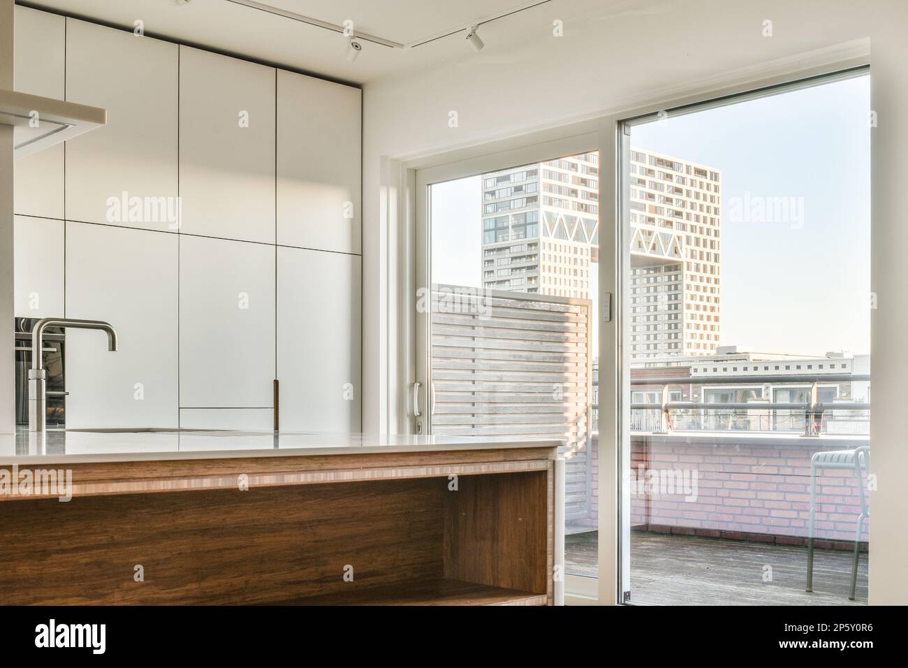 a modern kitchen with an open window overlooking the cityscapearl is in ...