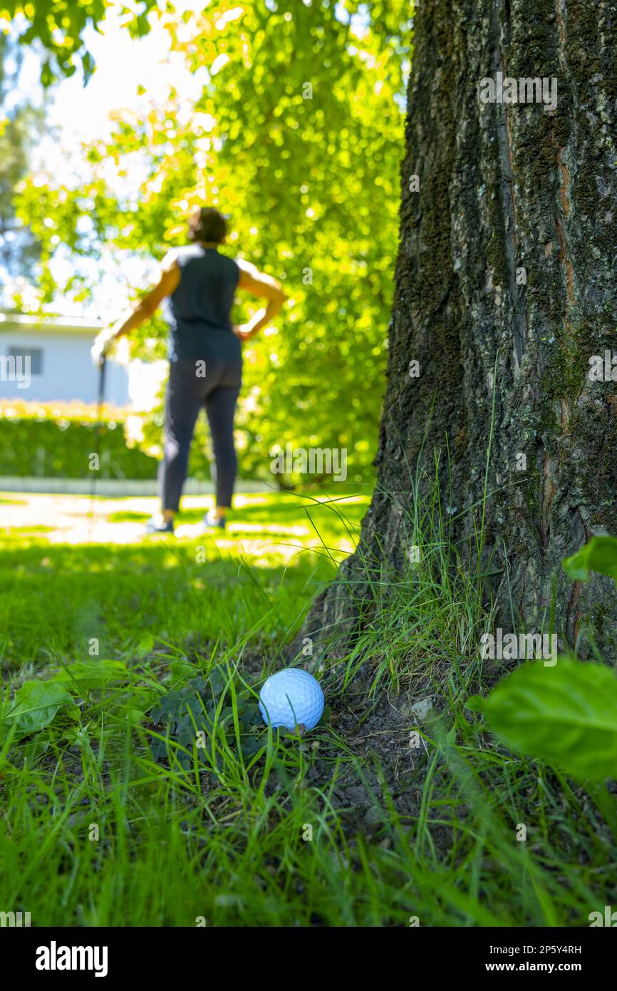 Golf Ball Lying on the Rough Grass and Golfer with Golf Club Searching ...
