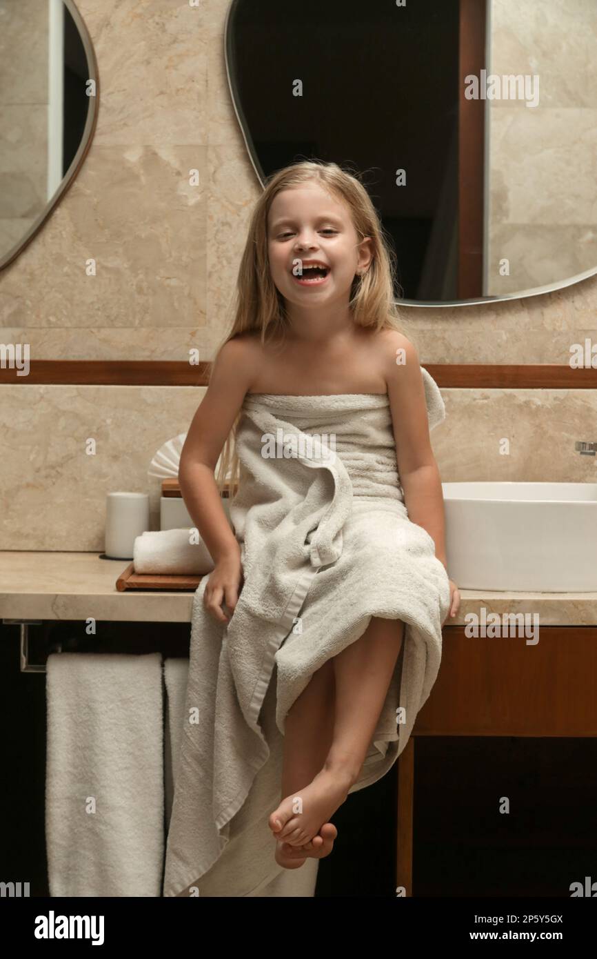 Portrait of cute little girl wrapped in towel in the bathroom Stock ...
